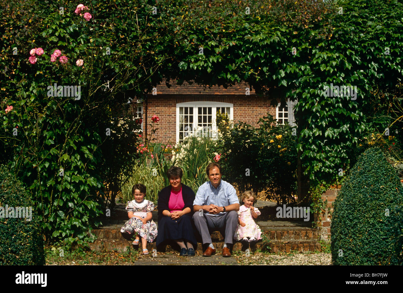 An active middle-aged, middle-class husband and wife seen in their neat ...