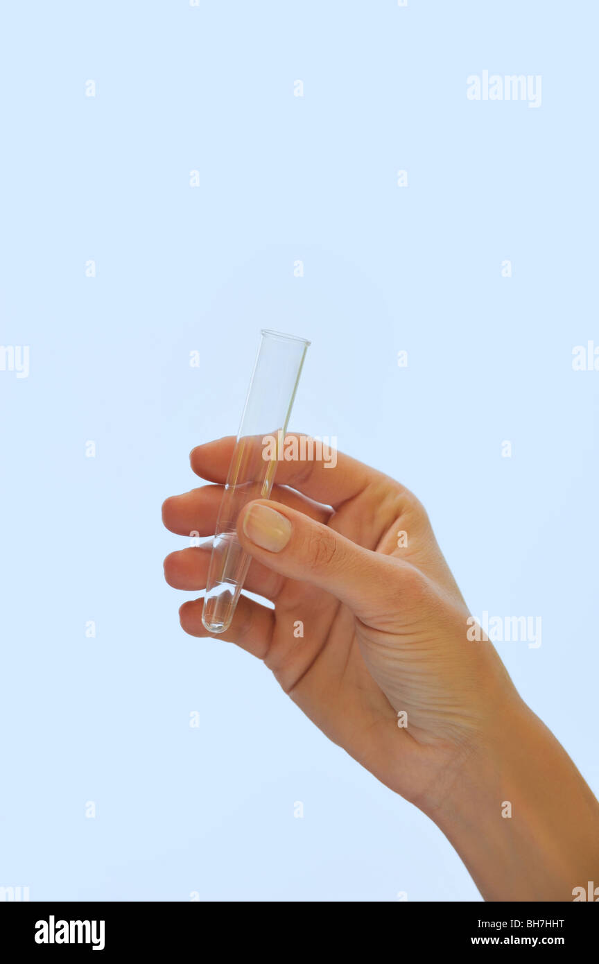 Hand holding test tube Stock Photo - Alamy