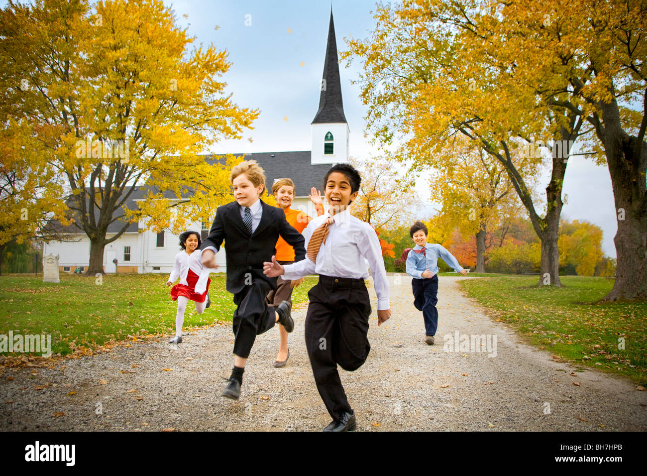 Kids playing in front of church on colorful fall morning Stock Photo ...