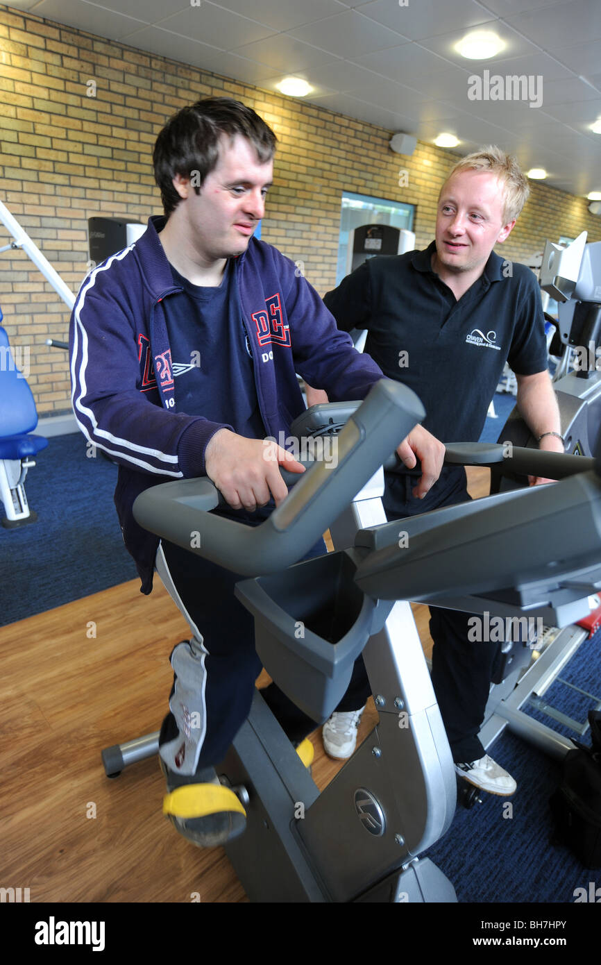 A young man with learning disabilities works out in a gym, North ...