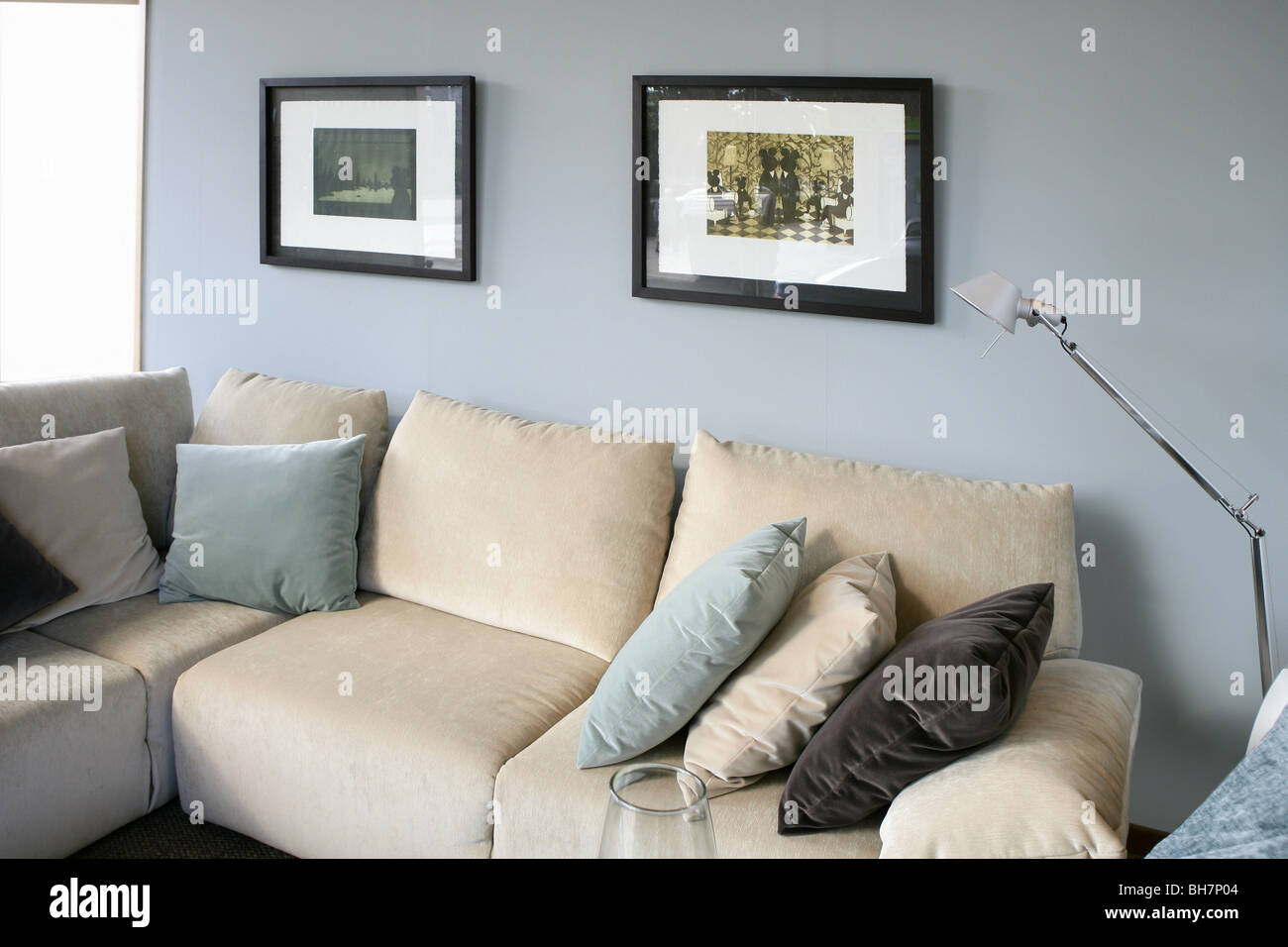 Living room with cream sofa, soft blue wall, interior design Stock ...