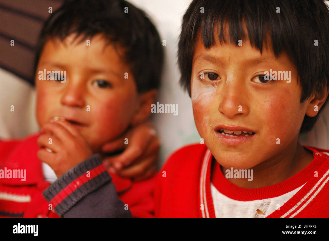 Ecuador, Latacunga, close-up portrait of a young boy wearing red and ...
