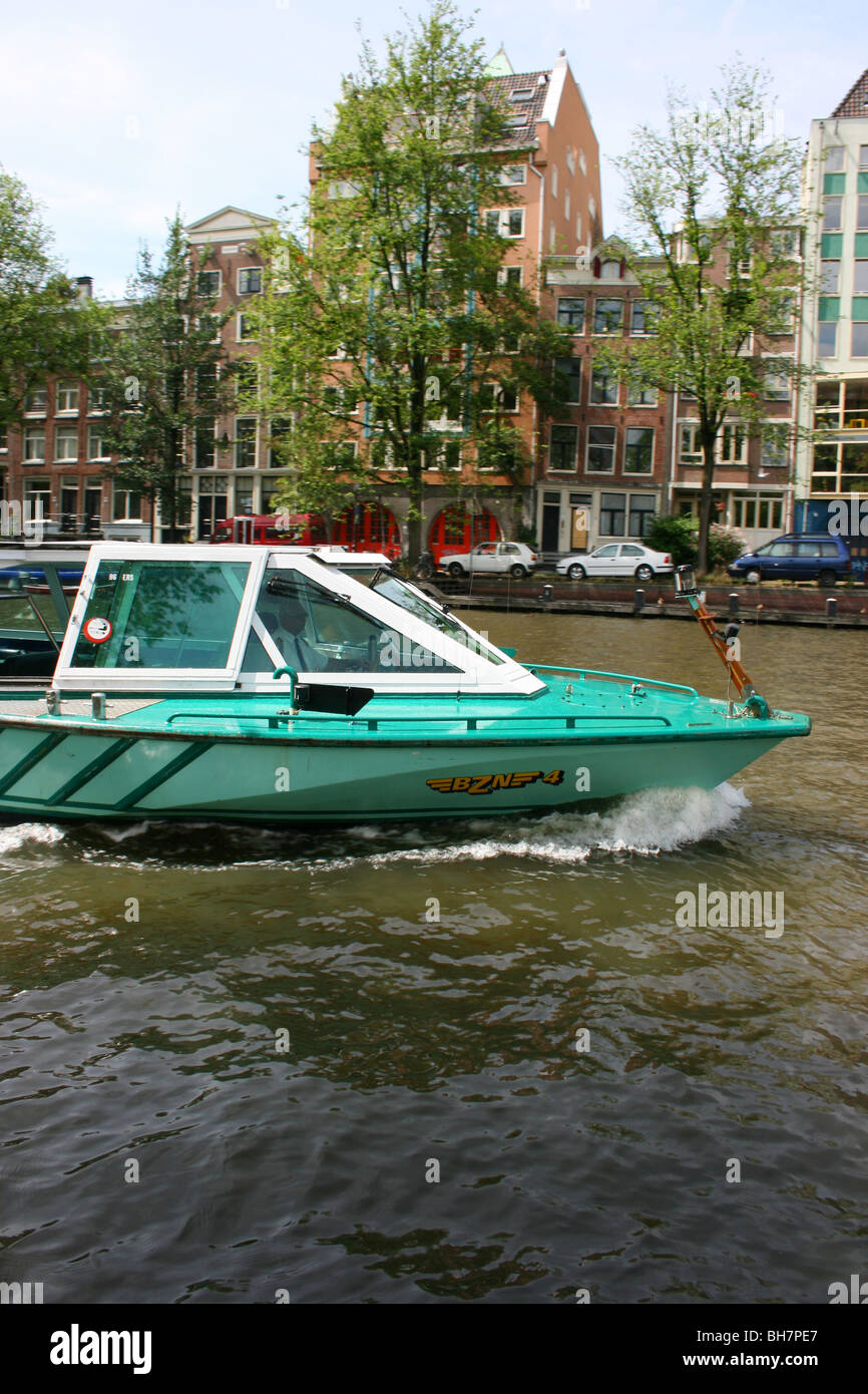 Modern canal boat cruising the canals of Amsterdam, Netherlands Stock ...