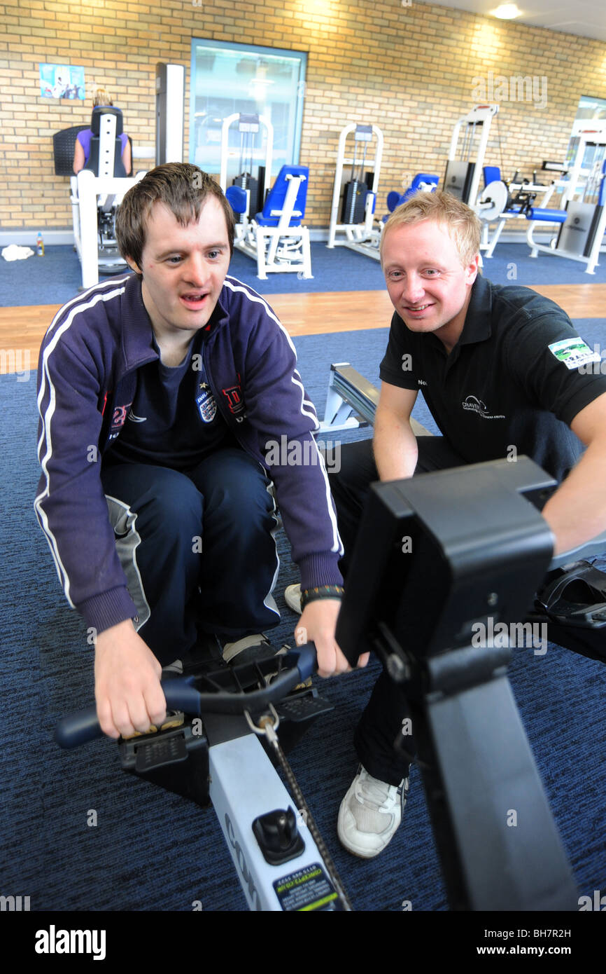 A young man with learning disabilities works out in a gym, North ...