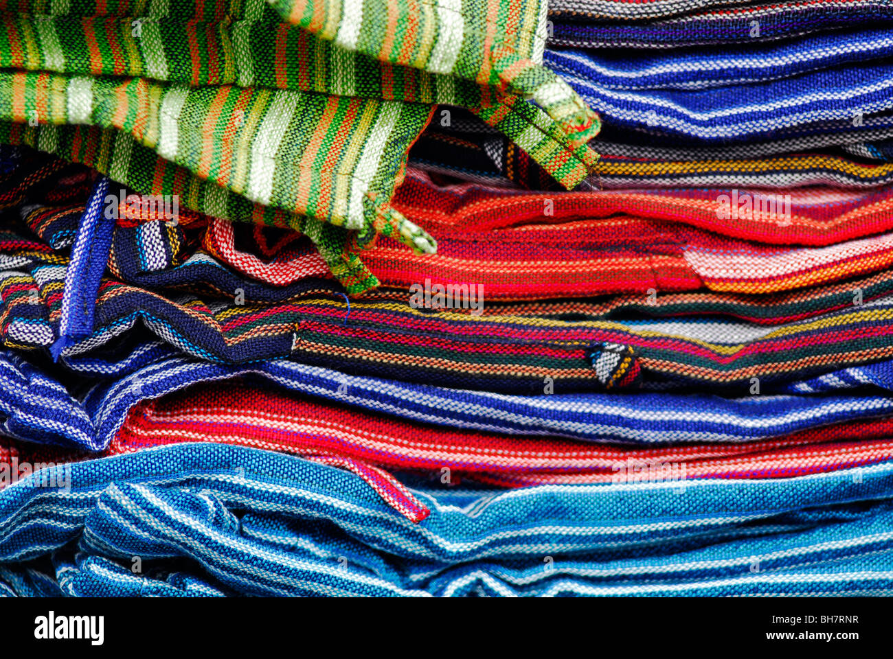 Ecuador, Otavalo, view of a stack of colorful textile materials at a ...