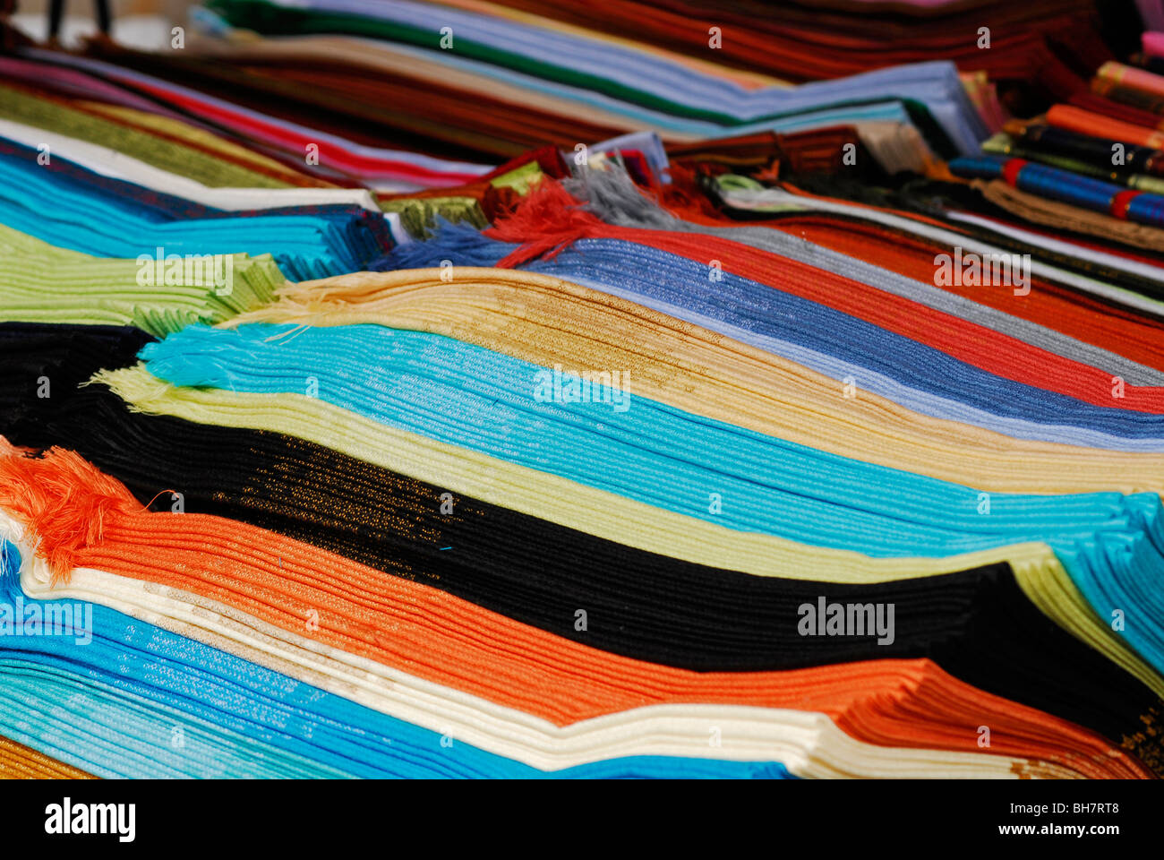 Ecuador, Otavalo, view of a stack of colorful textile materials at a ...