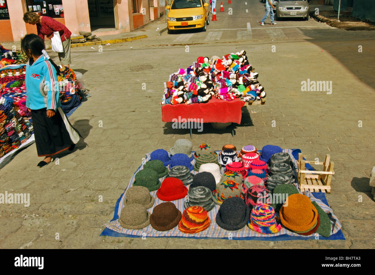 Ecuador, Otavalo, hats on display at a colourful stall in a street ...