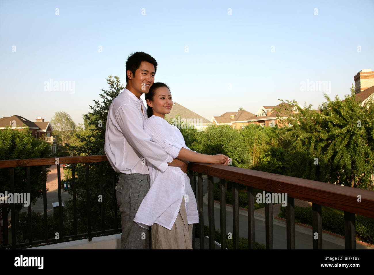 Chinese couple standing on balcony Stock Photo - Alamy