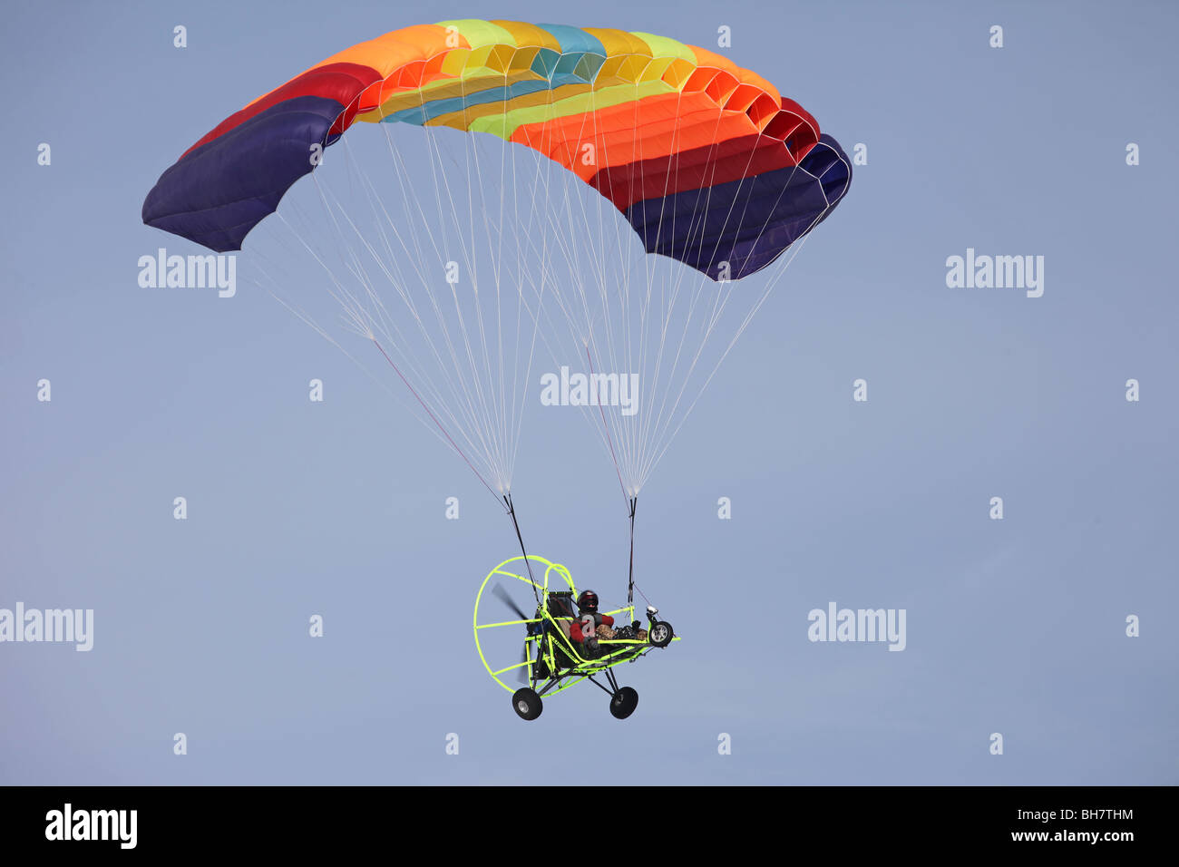 Powered parachute flying across ice and snow covered rural farms in ...
