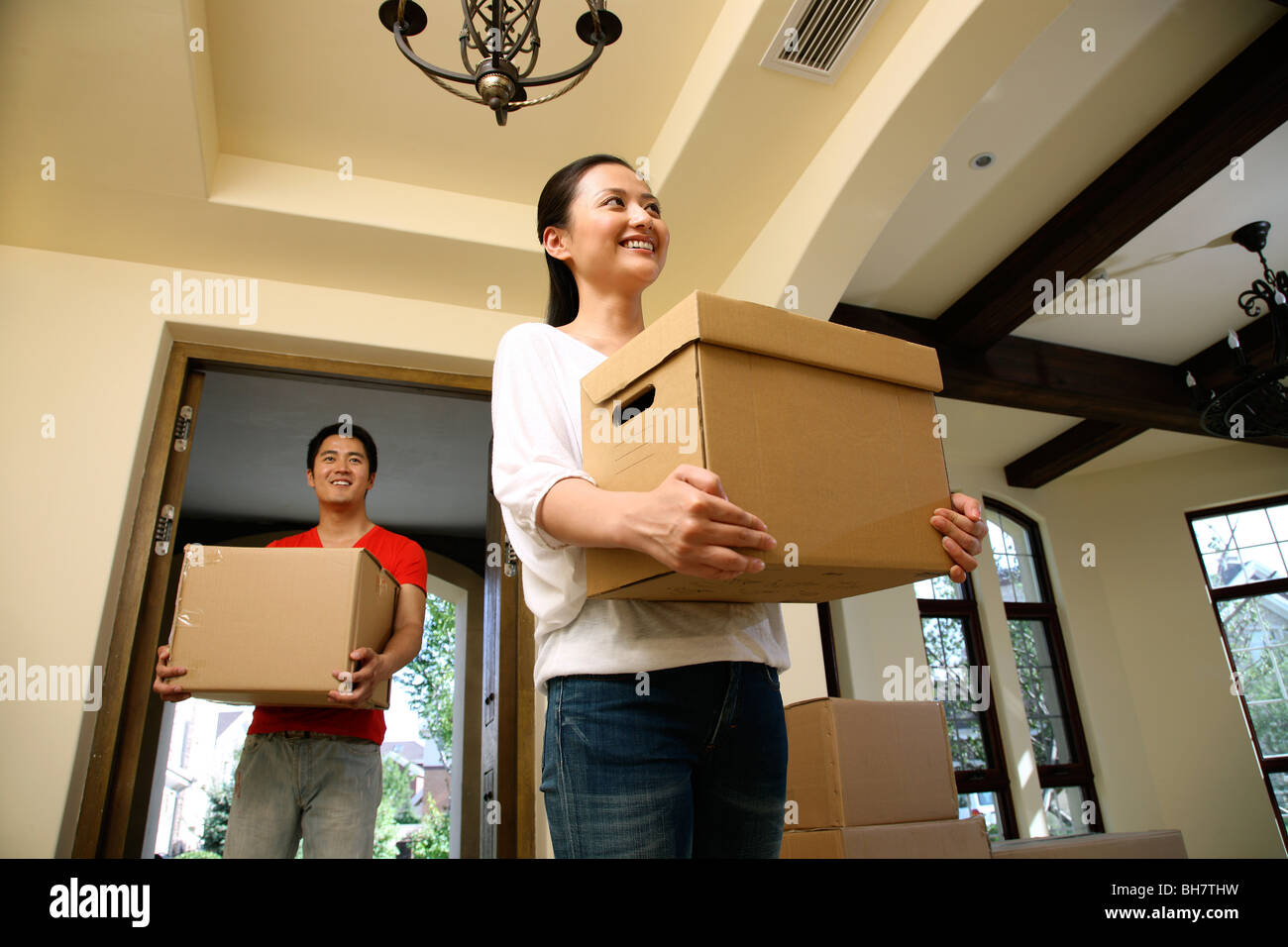 Chinese young couple moving into a new house Stock Photo - Alamy