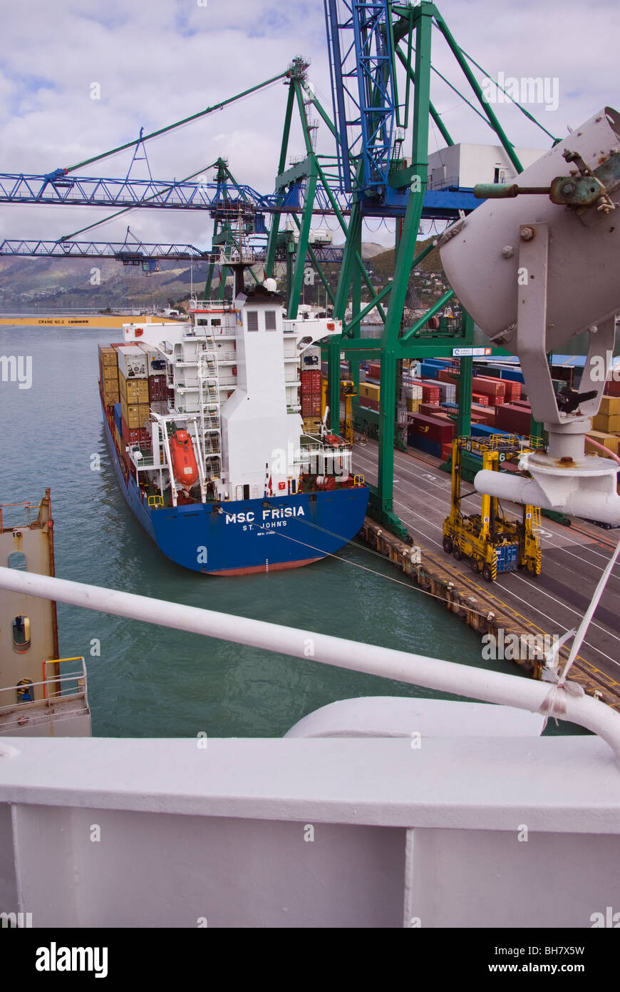 View of a ship alongside container terminal from another ship ...