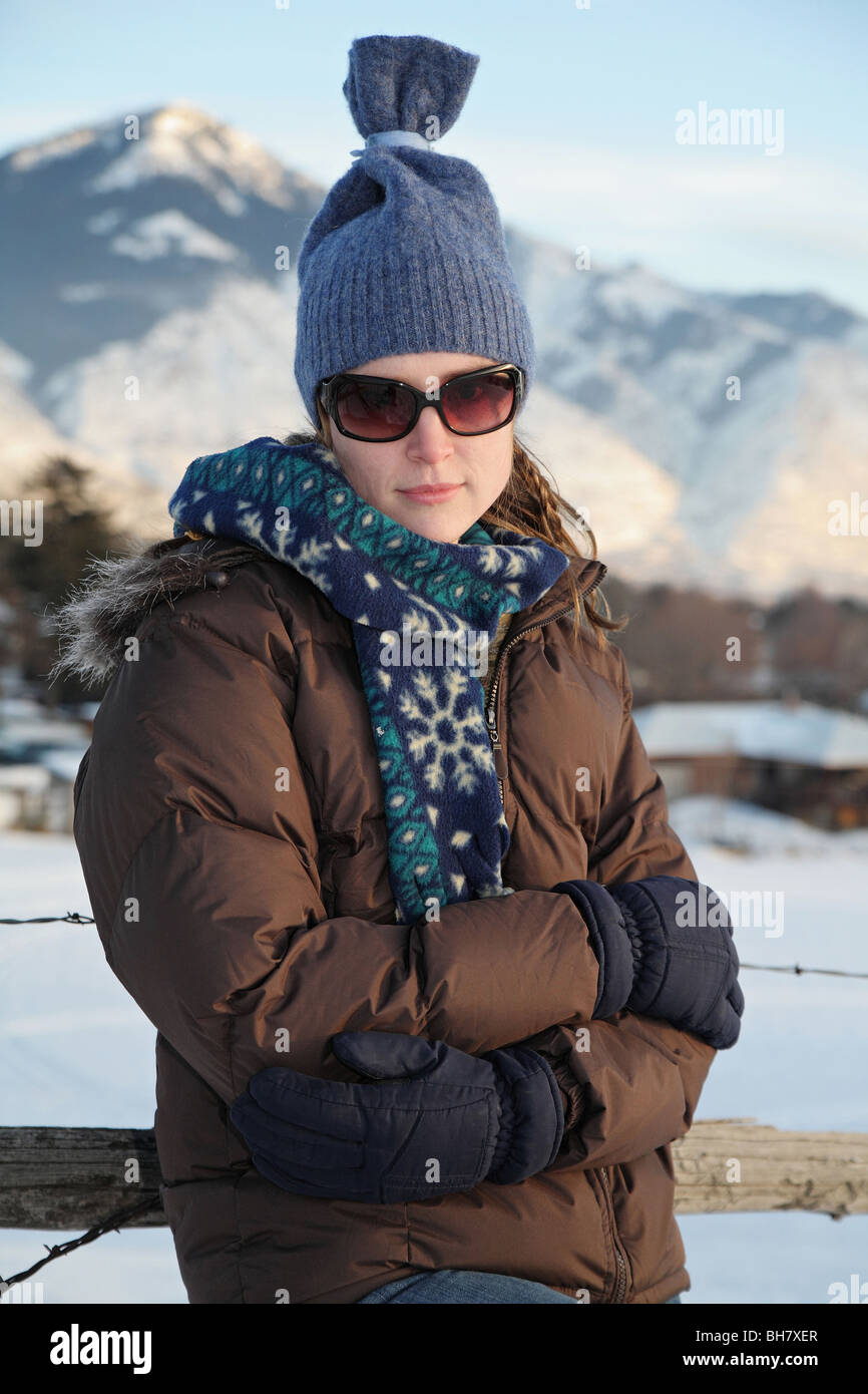 attractive woman with funny blue hat outdoor leaning on a fence Stock ...