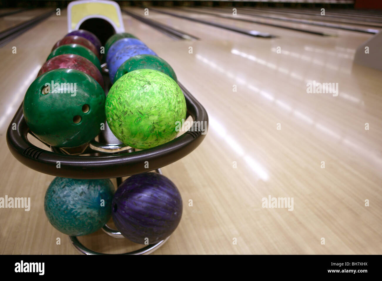 Bowling balls perspective in game center wooden floor Stock Photo - Alamy