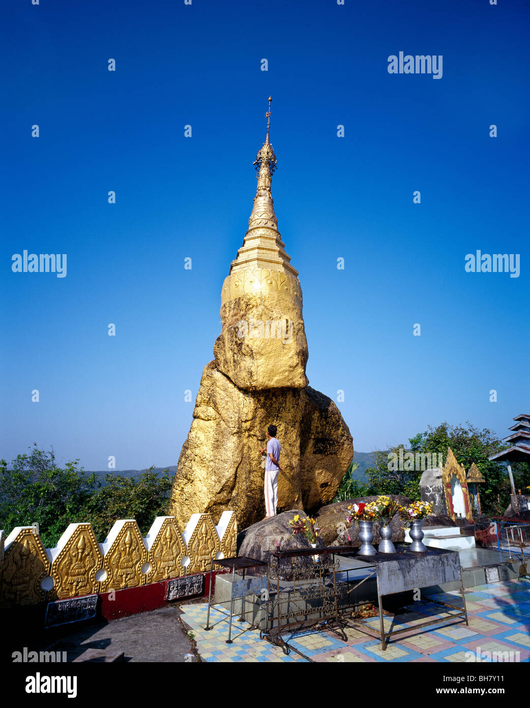 A man is standing in front of Nwa - La - Bo Pagoda also called little ...