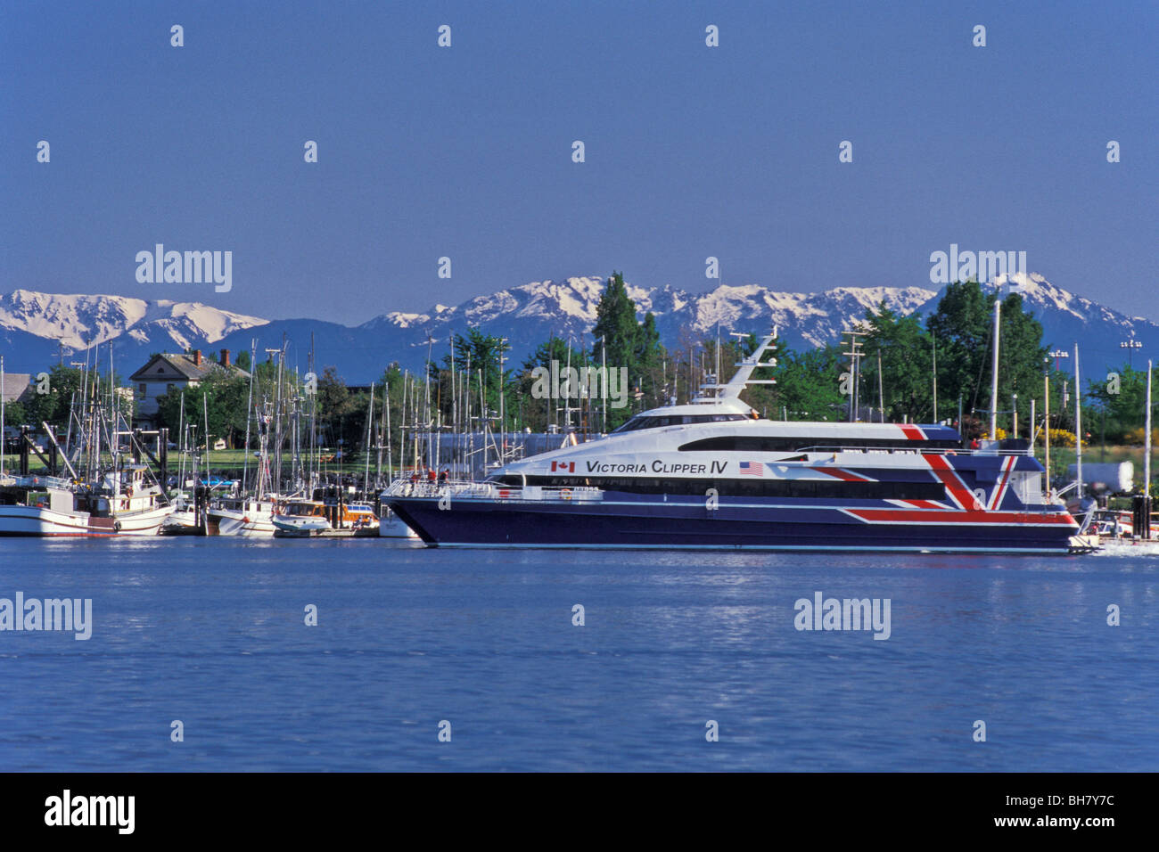 Victoria Clipper passenger ferry enters Victoria harbor, Small boat ...