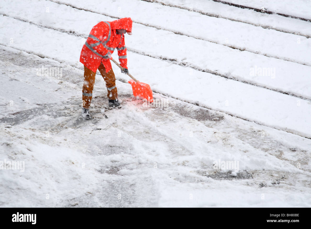 A man shoveling snow during heavy snowfall Stock Photo - Alamy