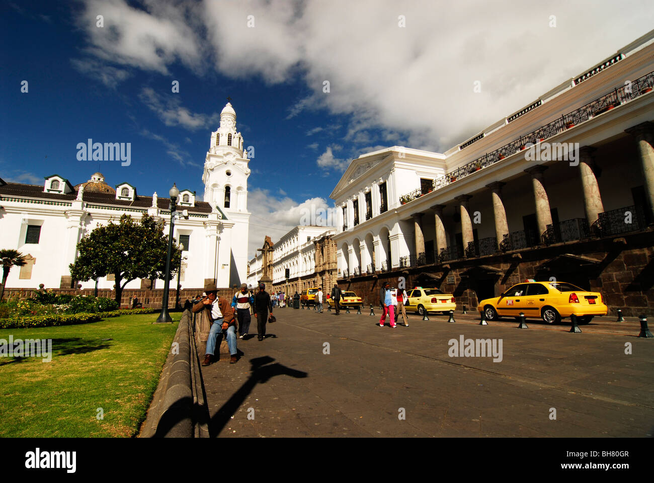 Ecuador, Quito, People walking in front of Quito's Cathedrol and taxis ...