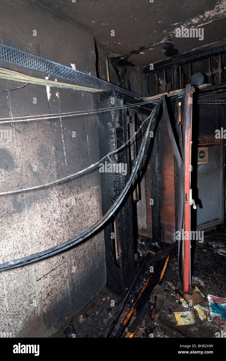 Burnt cables and electrical intake following shop fire Stock Photo - Alamy