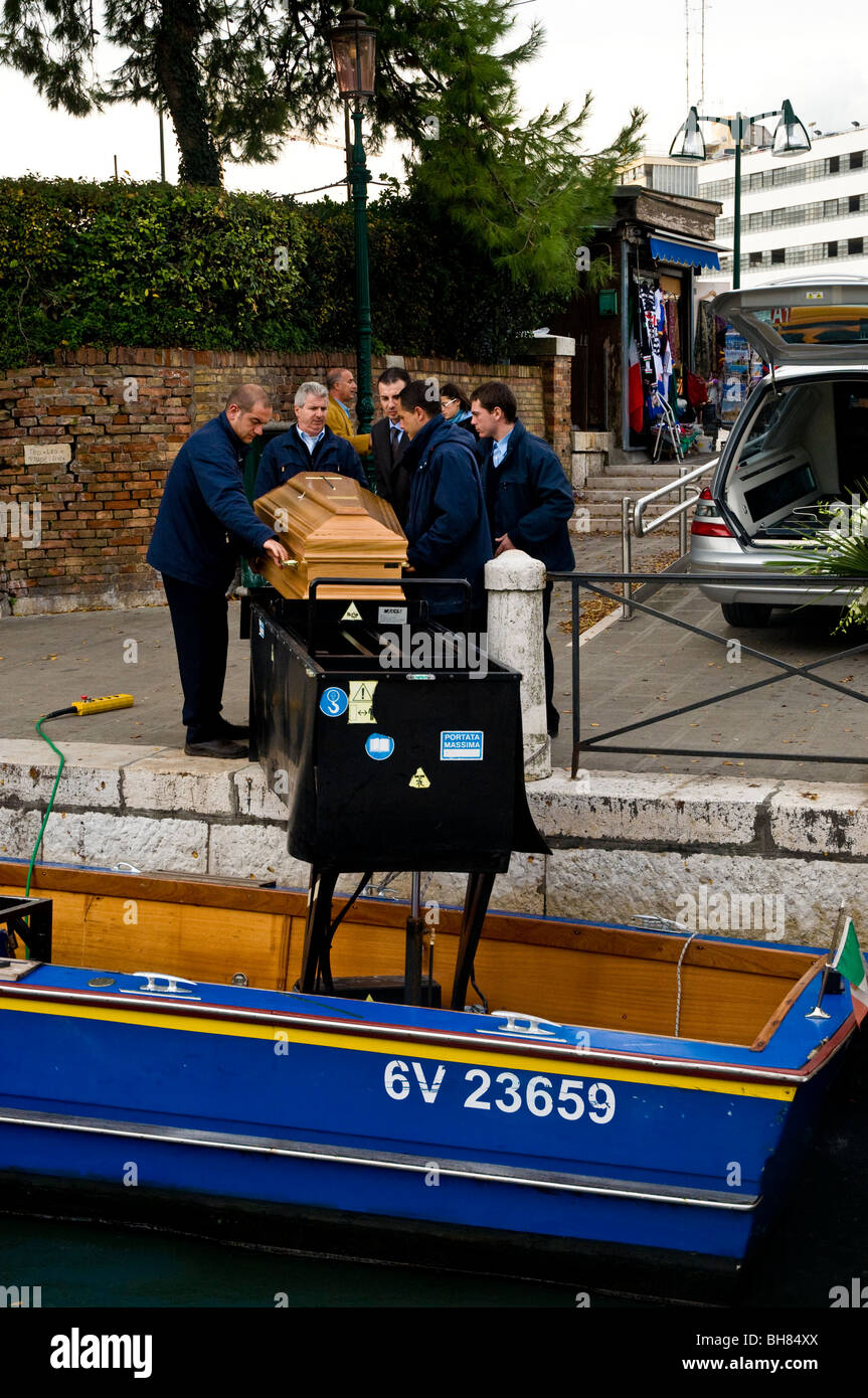 Venice special boat for transporting coffins arrive at the quayside and ...