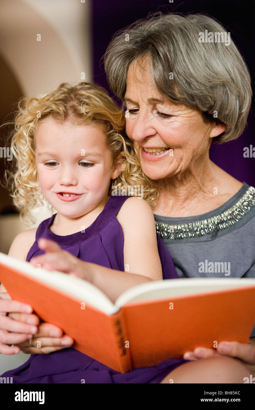 grandchild and grandma reading book Stock Photo - Alamy