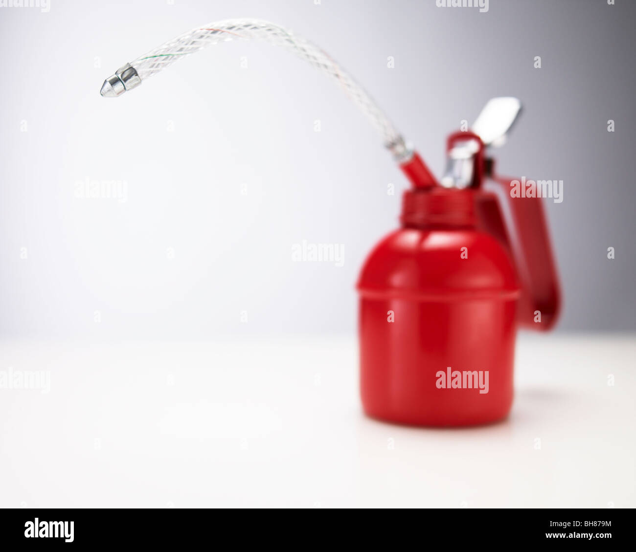 Traditional red oil can on a white background Stock Photo - Alamy