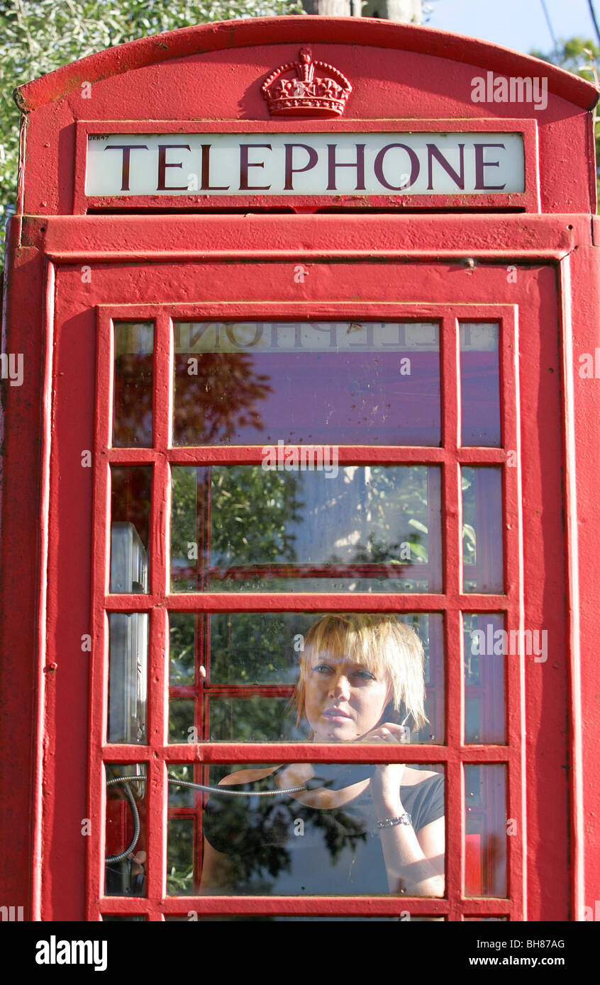 A woman chats on the phone in a public telephone box. Picture by James ...