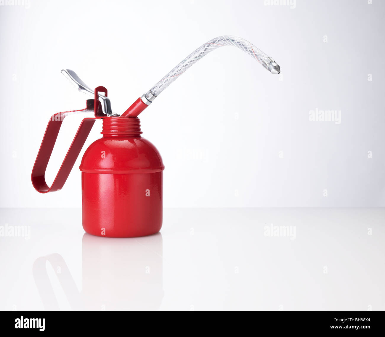 Traditional red oil can on a white background Stock Photo - Alamy