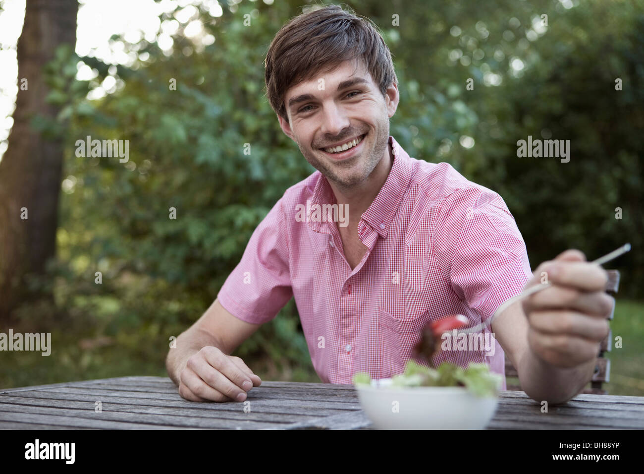 A man eating at a table outdoors, non-urban scene Stock Photo - Alamy