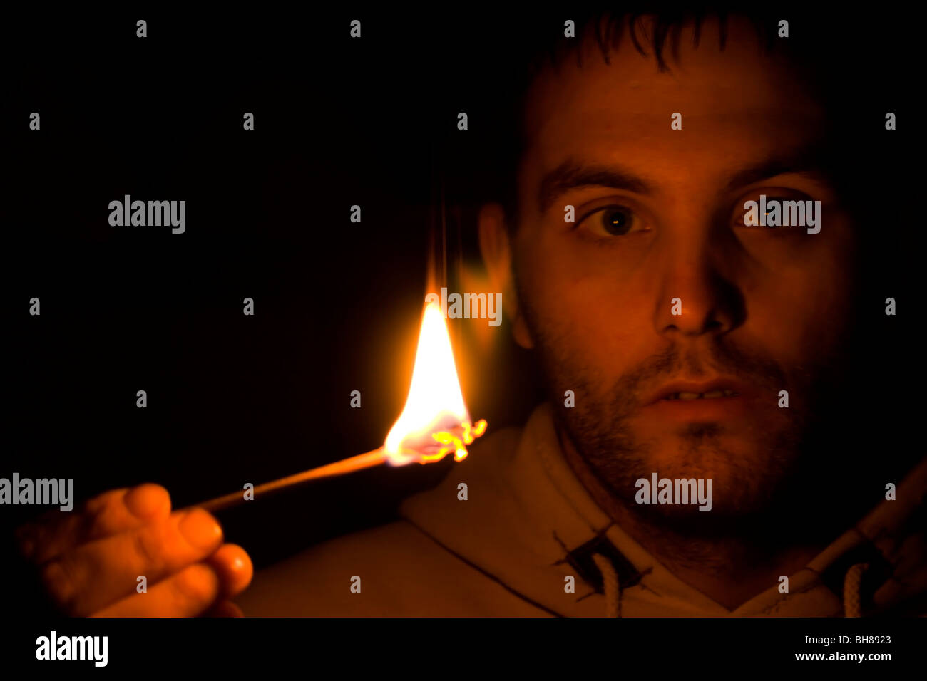 Scared man with flame Stock Photo - Alamy