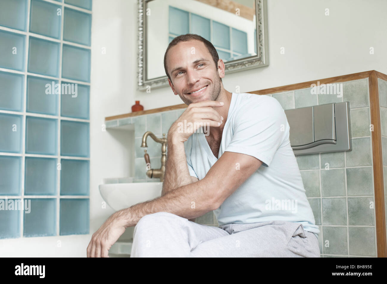 A man sitting in his bathroom Stock Photo - Alamy