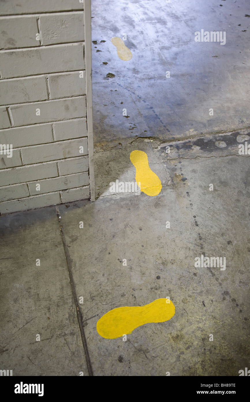 Painted footprints on a concrete pathway Stock Photo - Alamy