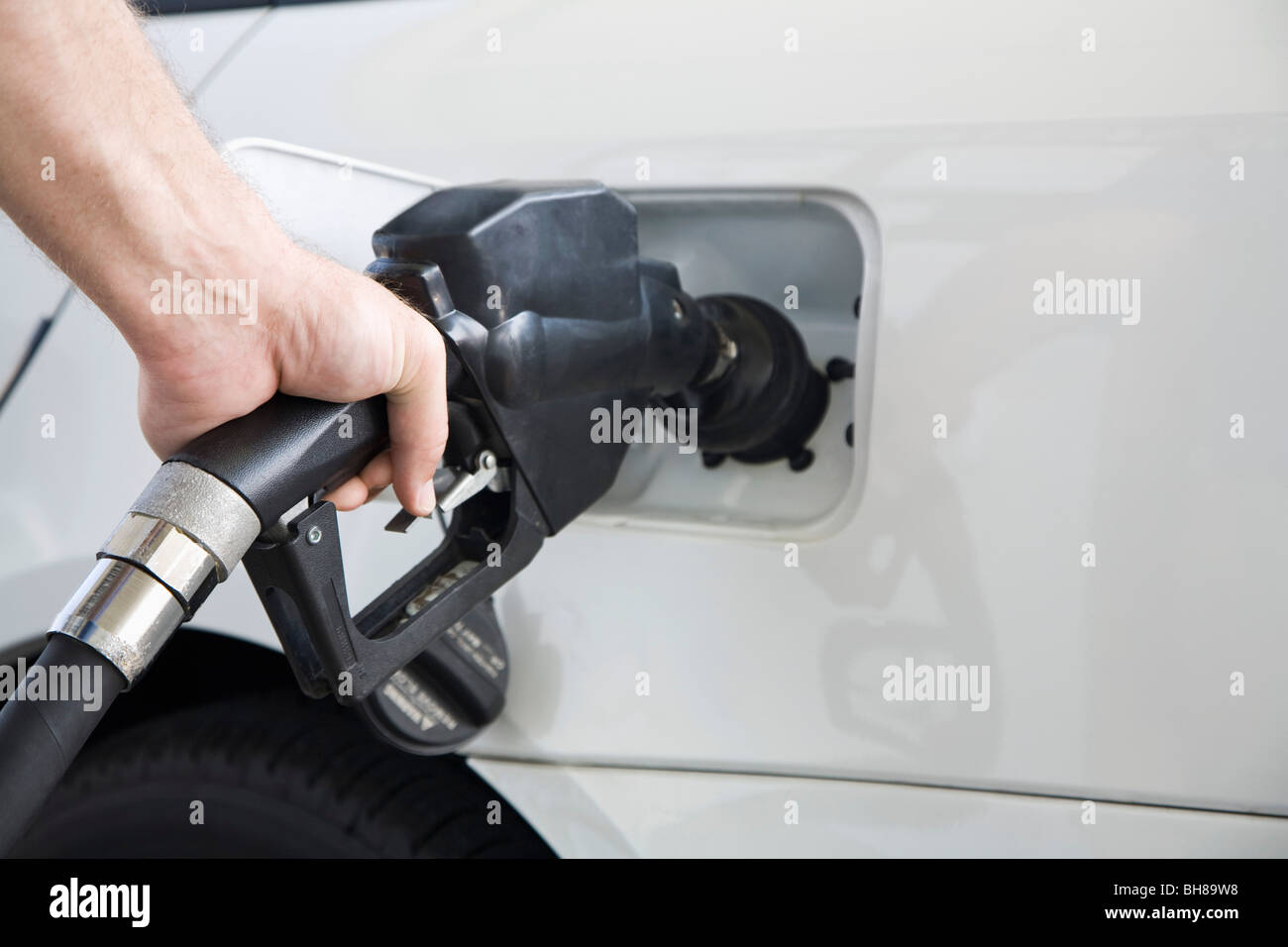 A man's hand pumping gas, close-up Stock Photo - Alamy