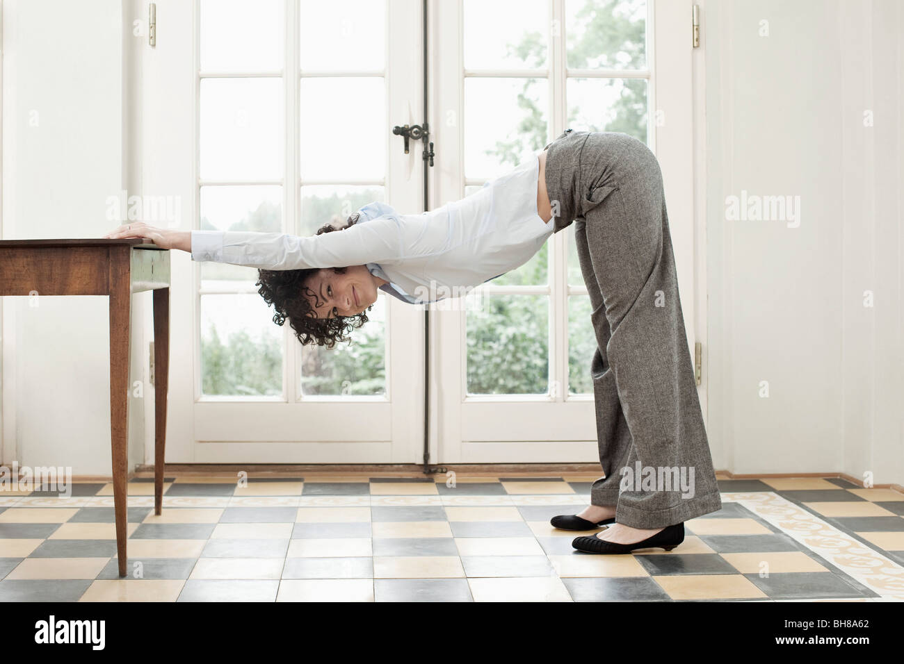 Woman bending over table hi-res stock photography and images - Alamy