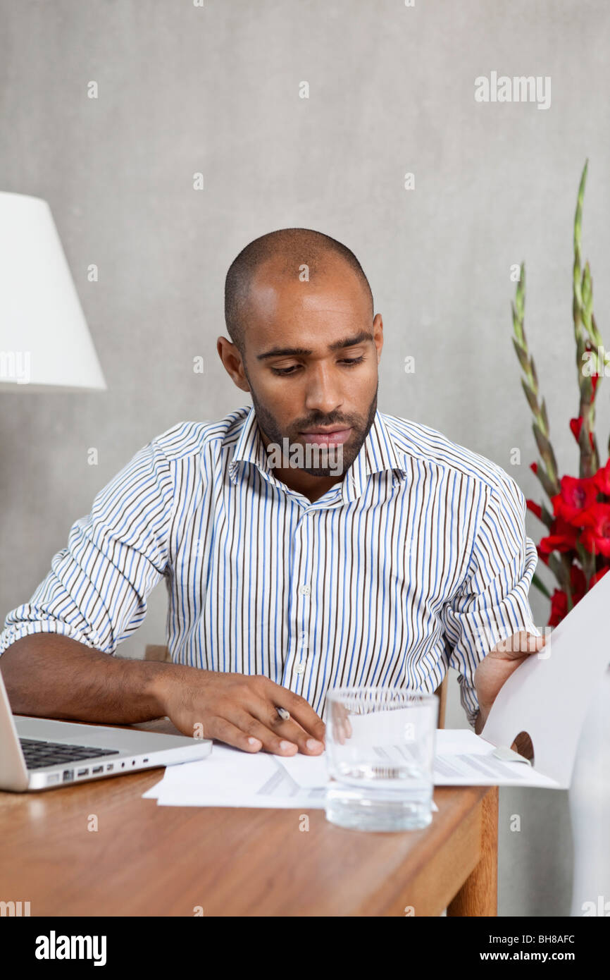 A businessman looking at documents Stock Photo - Alamy