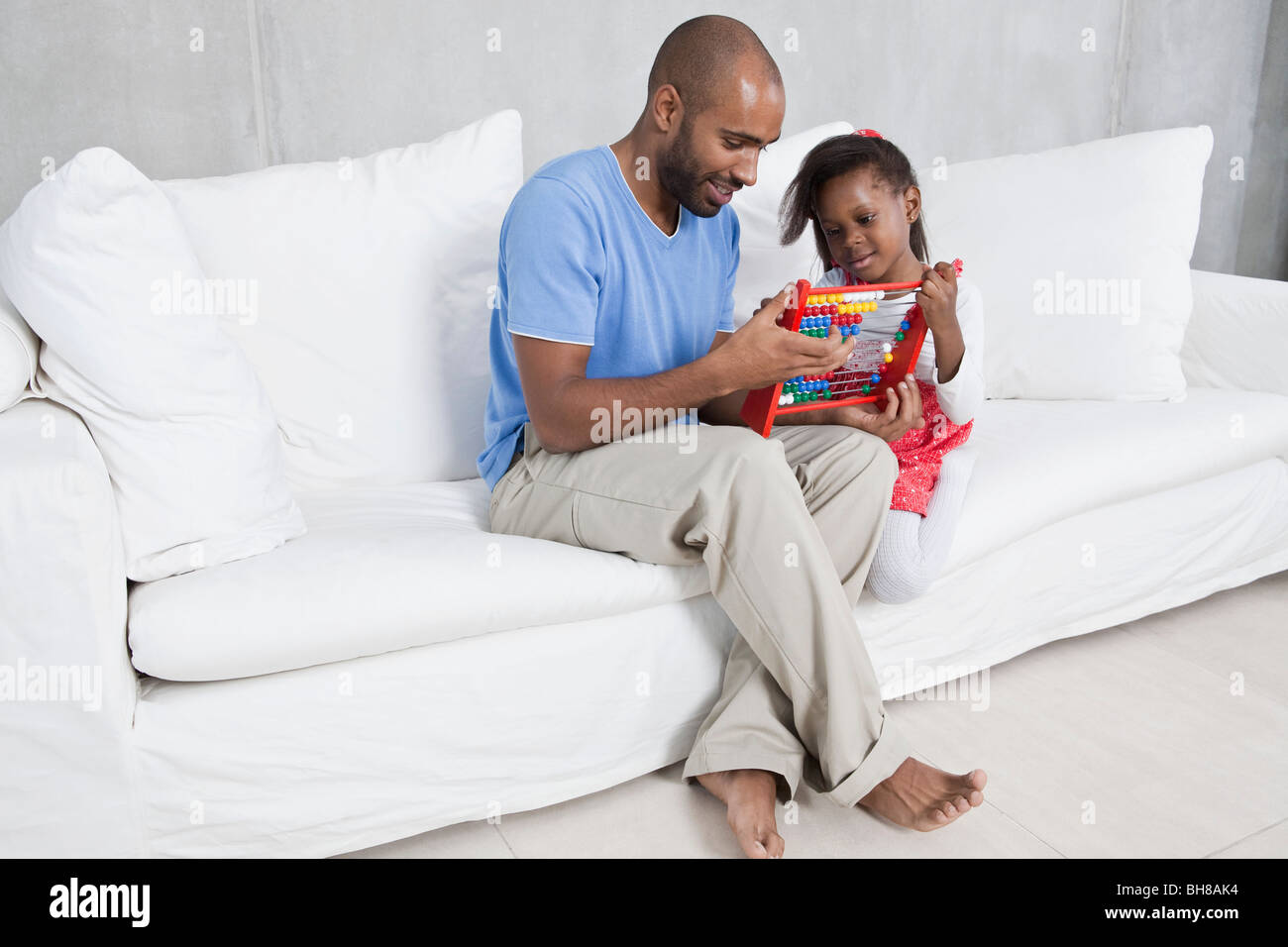 A father showing his young daughter how to use an abacus Stock Photo ...