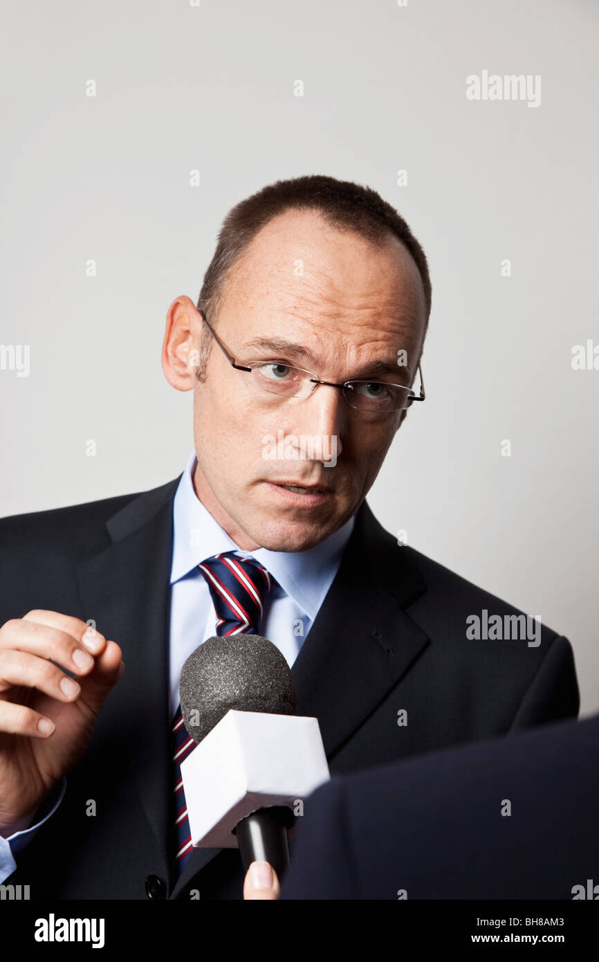 A man in a suit being interviewed Stock Photo - Alamy