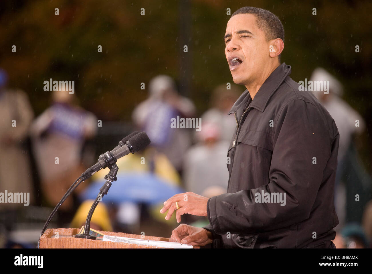 US Senator Barack Obama speaking at podium in pouring rain at ...