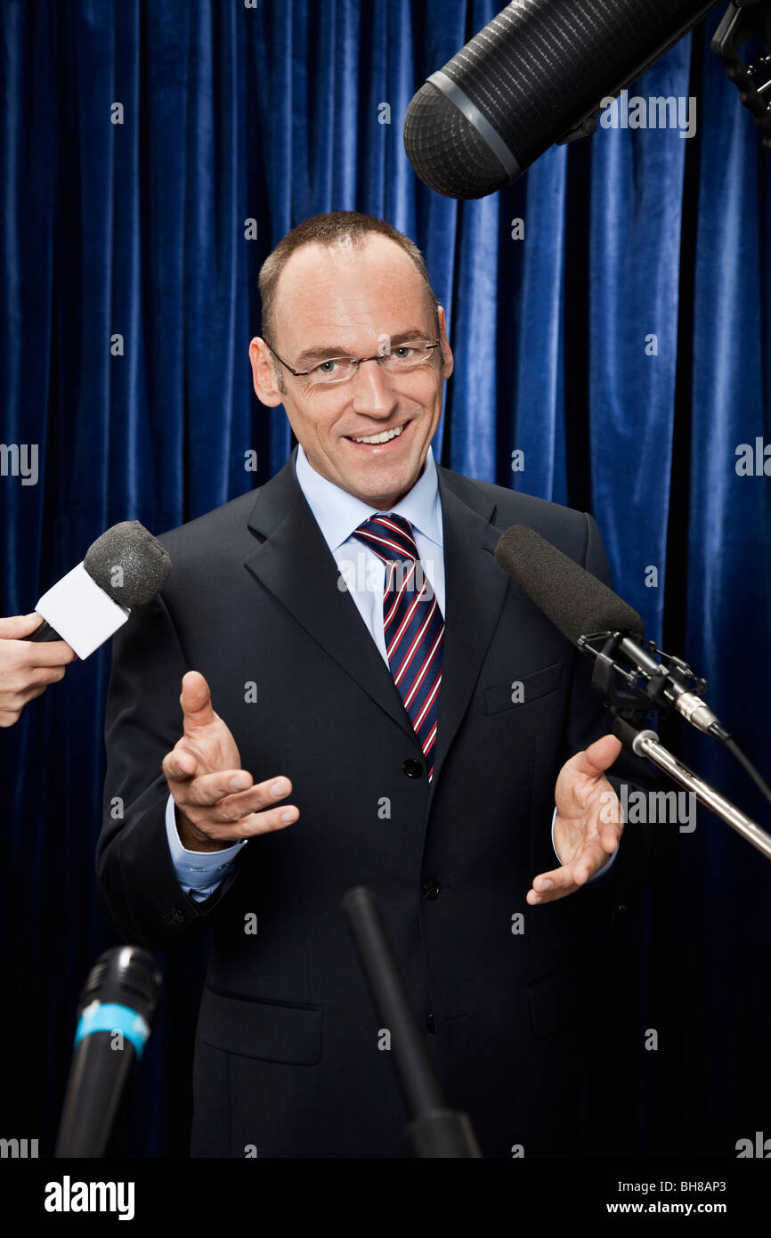 Portrait of a man in a suit being interviewed by the media Stock Photo ...