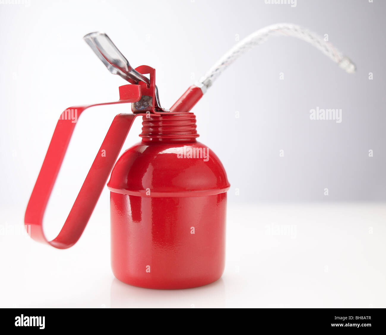 Traditional red oil can on a white background Stock Photo - Alamy
