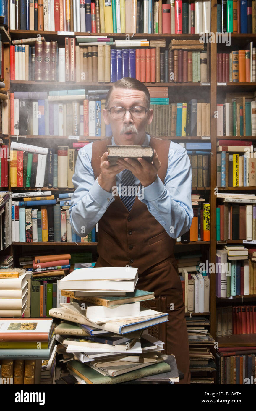 Blowing dust off a book hi-res stock photography and images - Alamy