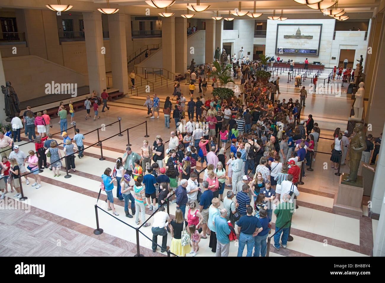 Tourists stand in line for tickets with view of U.S. Capitol through ...