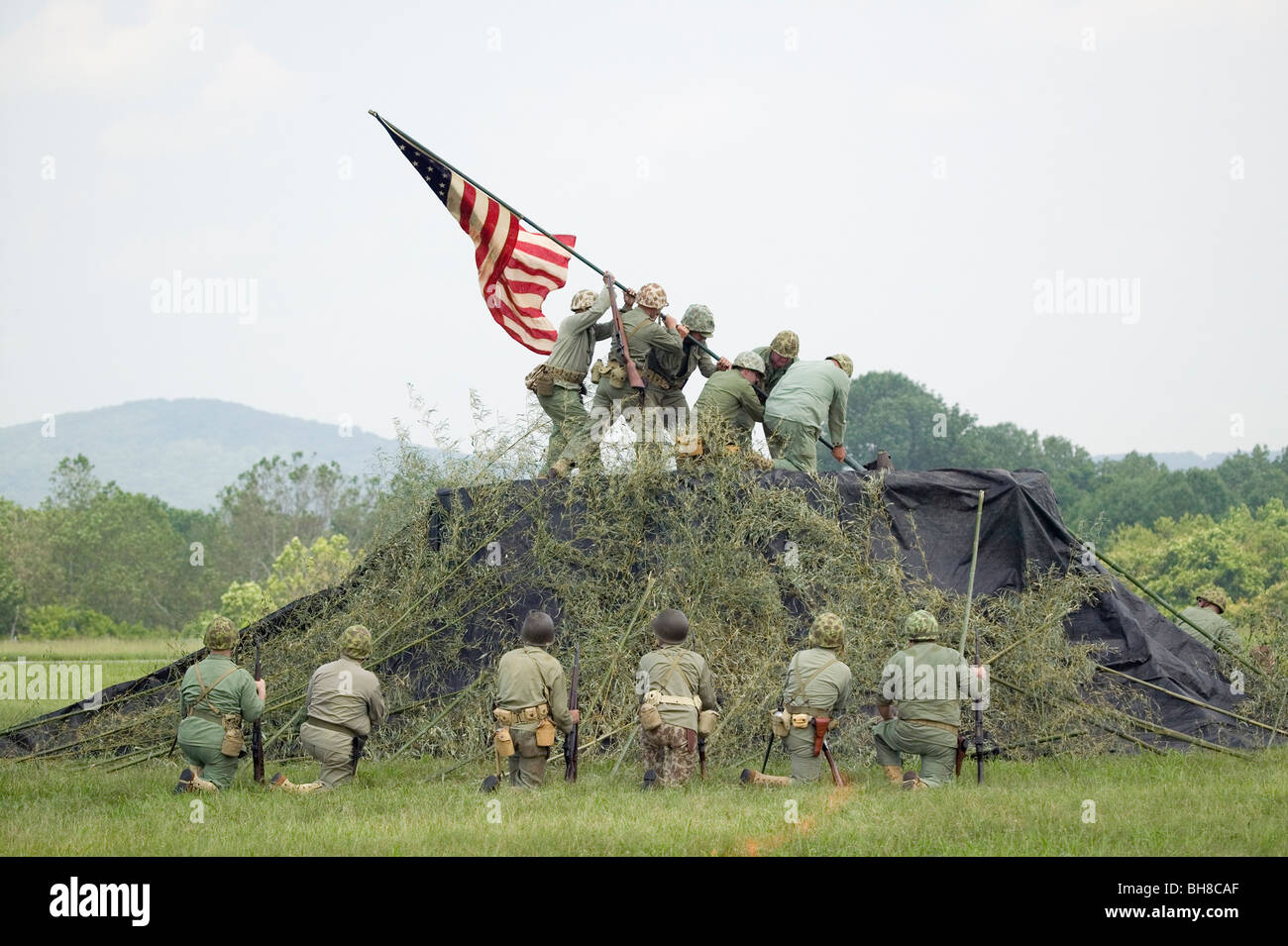 A World War II reenactment of US Marines raising the American flag on ...