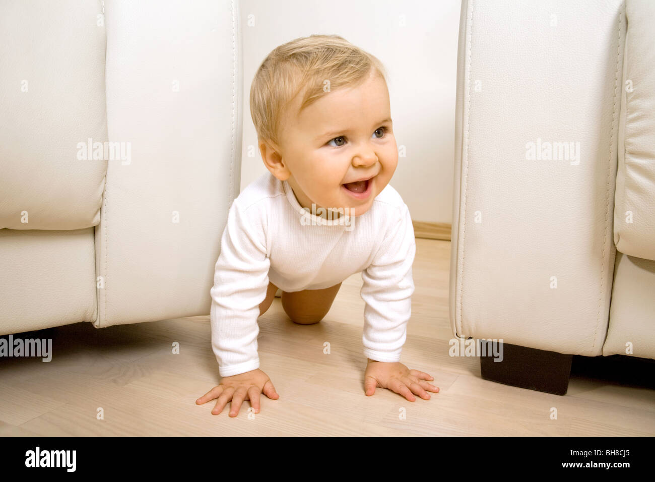 adorable baby crawling on the floor in living room Stock Photo - Alamy
