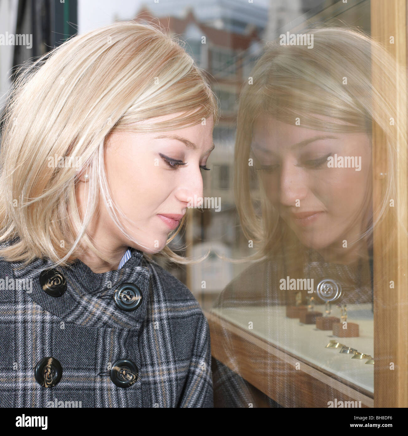 woman looking at shop window Stock Photo - Alamy
