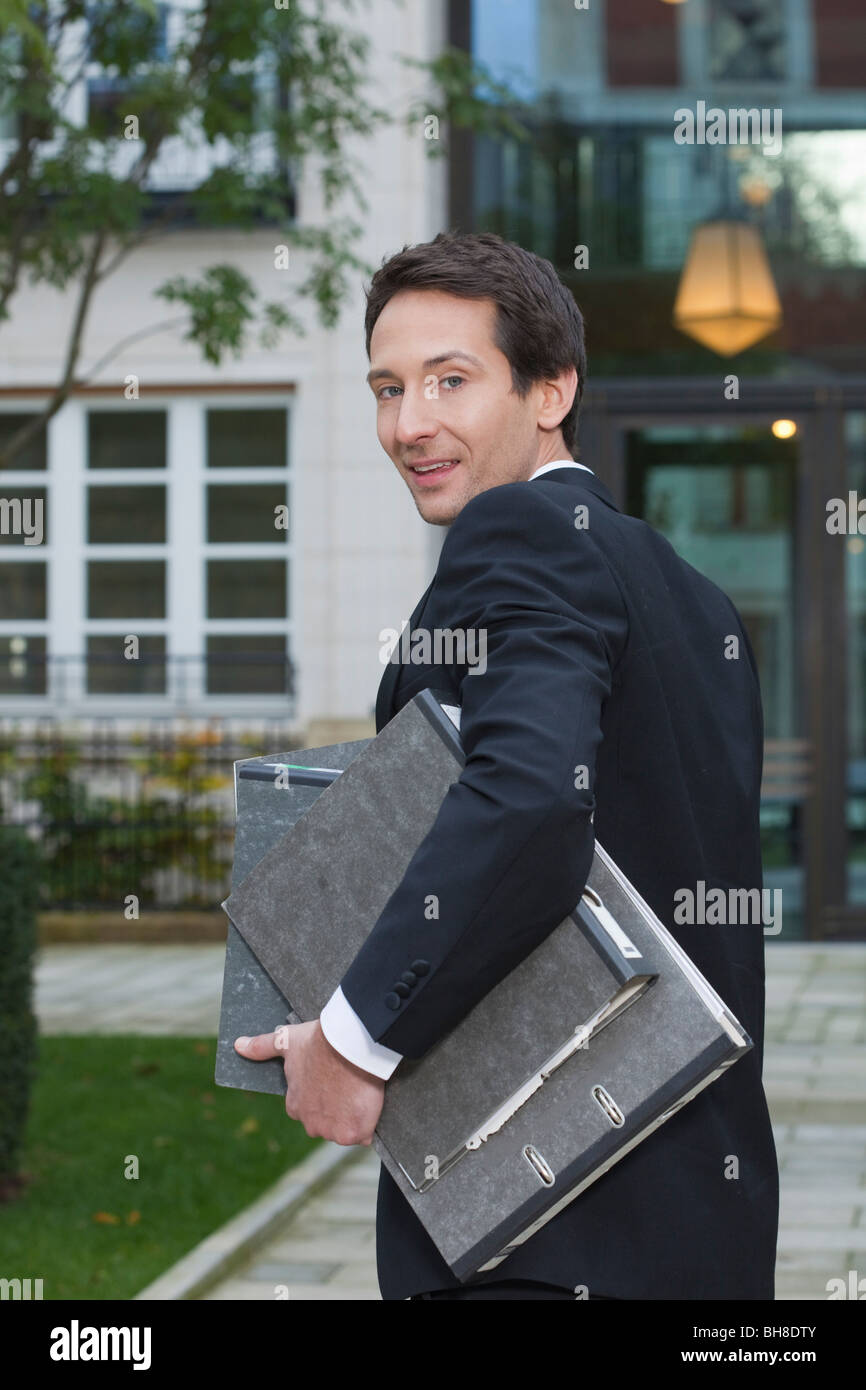 businessman carrying files, outside Stock Photo - Alamy