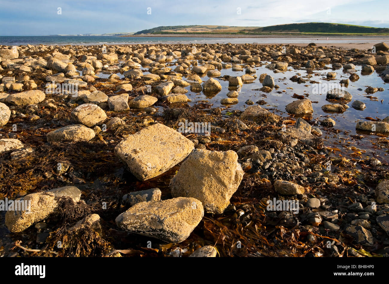 Rocks and stones on the beach at New England Bay on the Mull of ...
