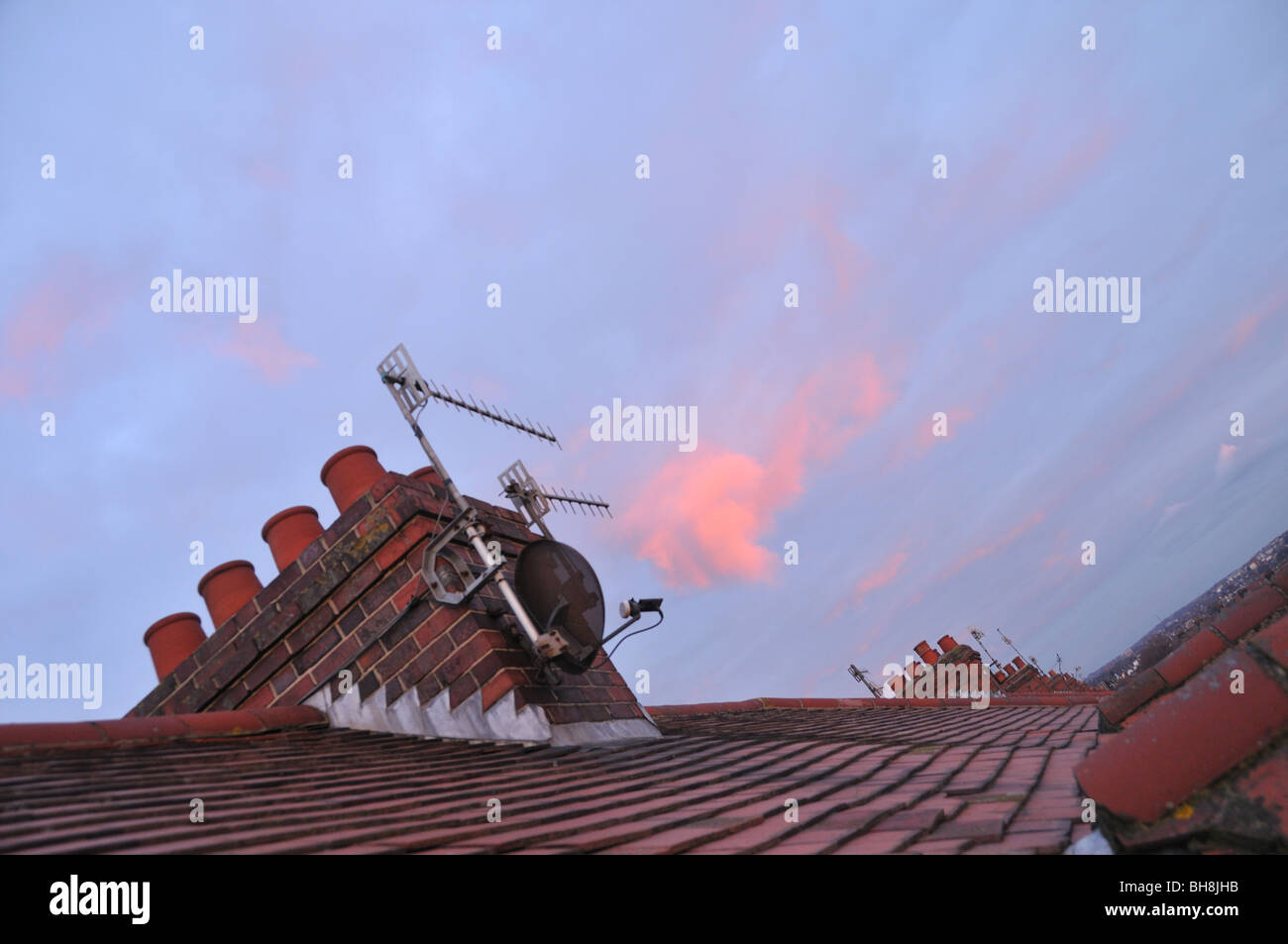 Detail of a roof and sunset clouds Stock Photo - Alamy