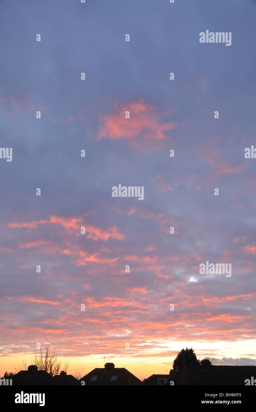 Beautiful sunset clouds with a silhouette of a town Stock Photo - Alamy