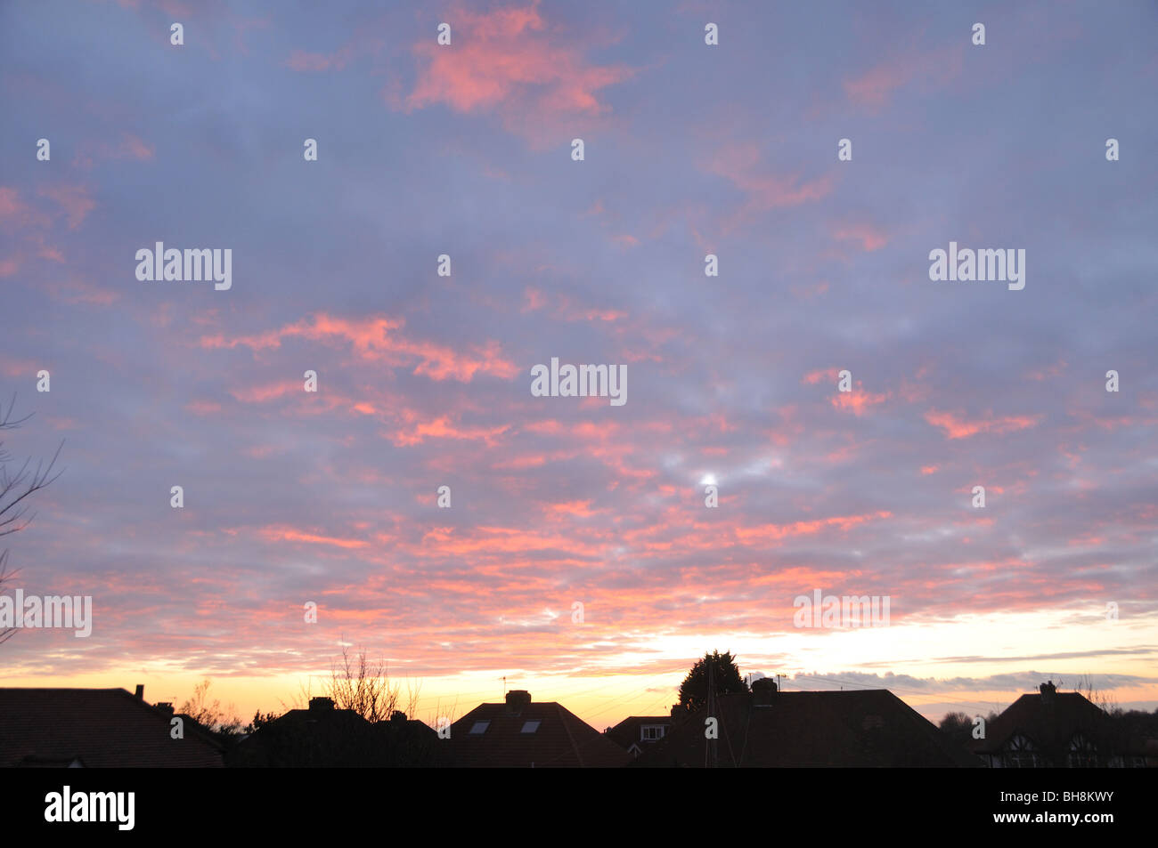 Beautiful sunset clouds with a silhouette of a town Stock Photo - Alamy