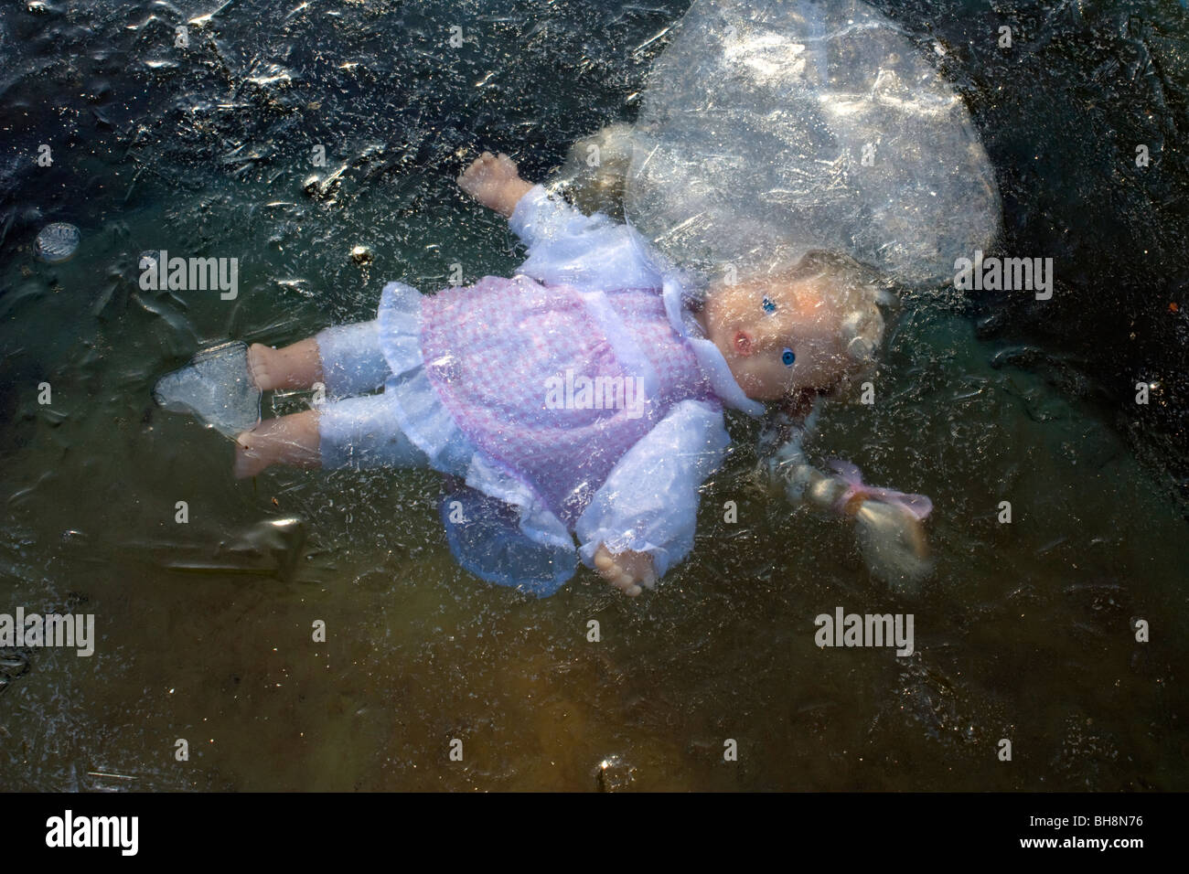 Doll trapped under ice Stock Photo - Alamy